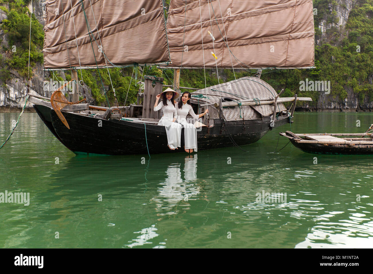Young women on a traditional junk (sailboat) in Halong Bay, Vietnam ...