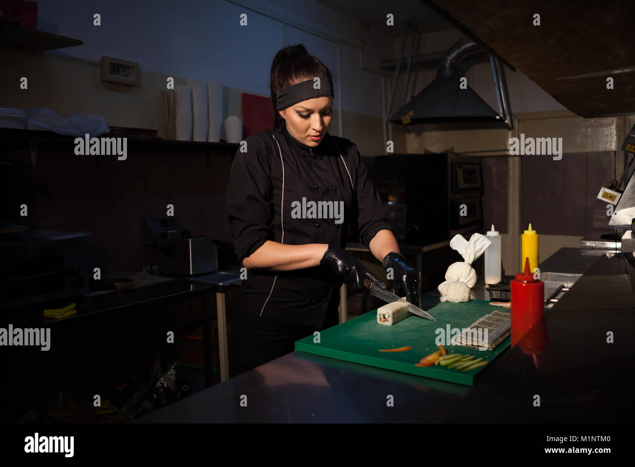 girl sushi chef prepares food in the kitchen at restaurant Stock Photo ...