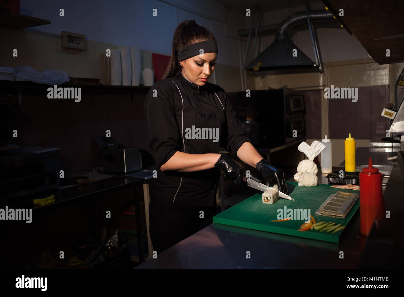 girl sushi chef prepares food in the kitchen at restaurant Stock Photo ...