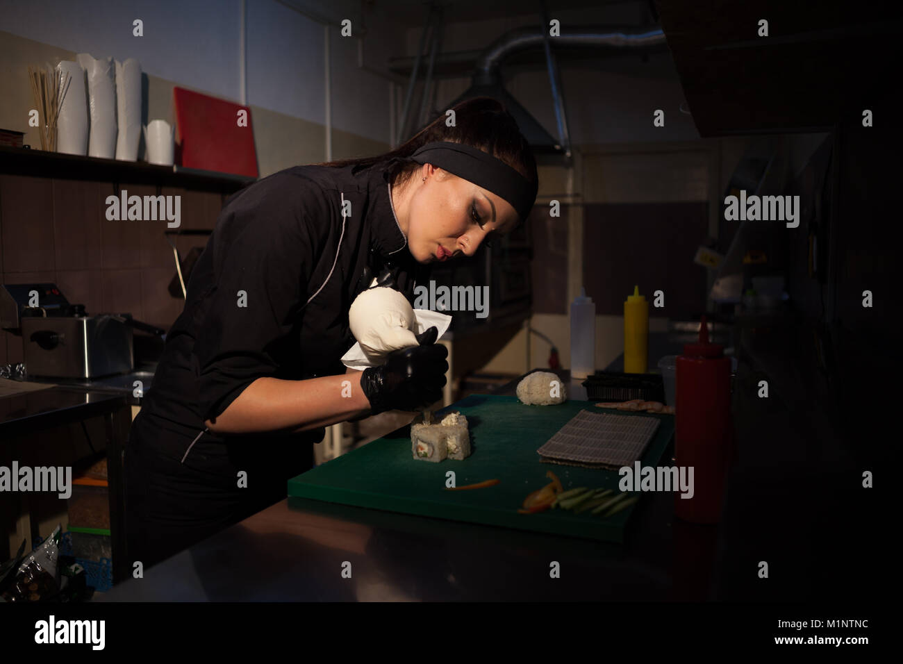 girl sushi chef prepares food in the kitchen at restaurant Stock Photo ...