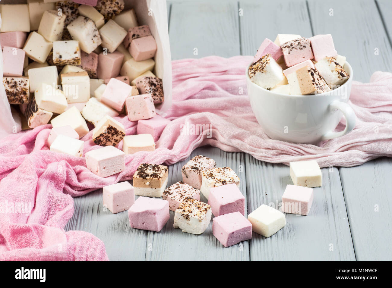 assorted marshmallow on a gray table in a cup, pink scarf Stock Photo ...