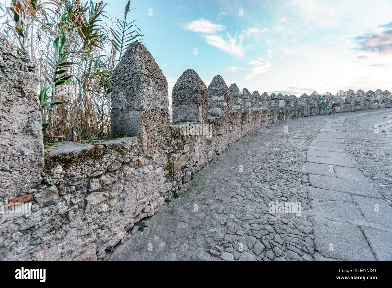 Wall and paved street Stock Photo - Alamy