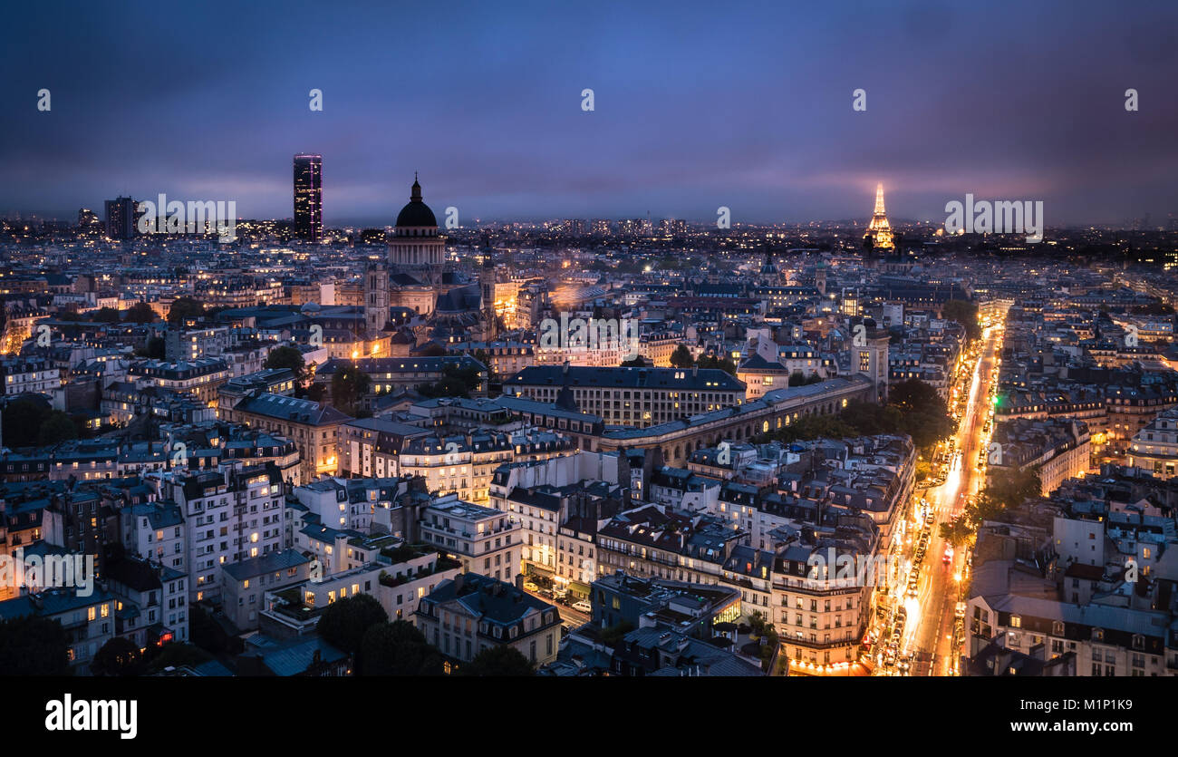 Paris city of lights at night with the Eiffel tower in the clouds Stock ...