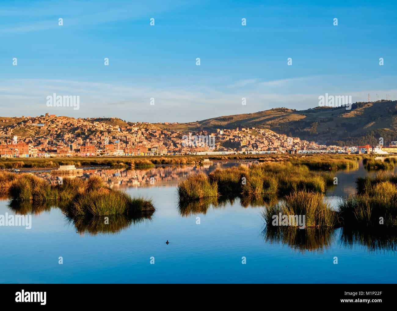 Lake Titicaca and cityscape of Puno at sunrise, Peru, South America ...