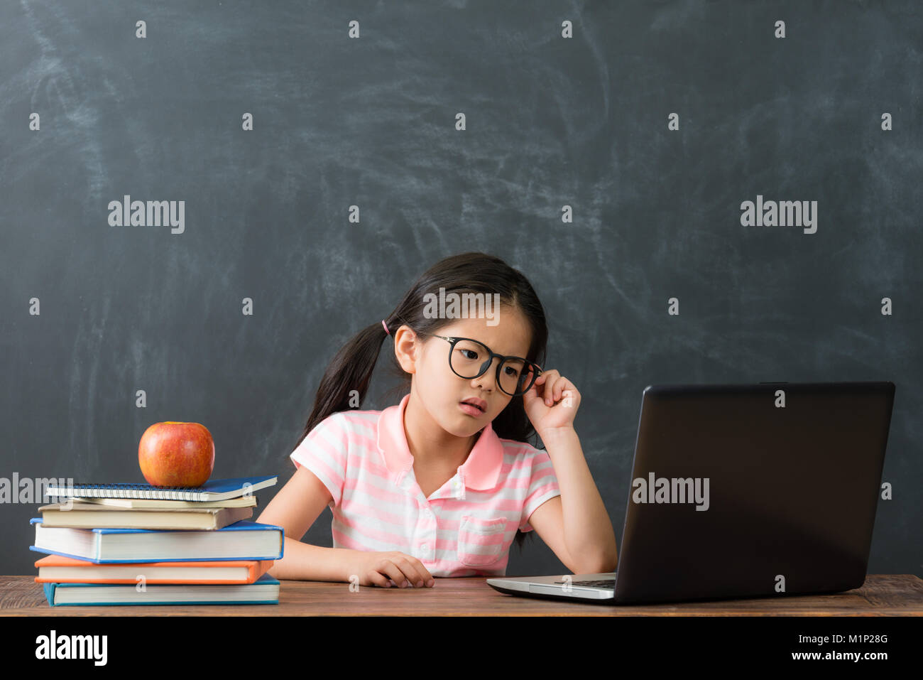 unhappy lovely female kid student looking at laptop computer feeling ...