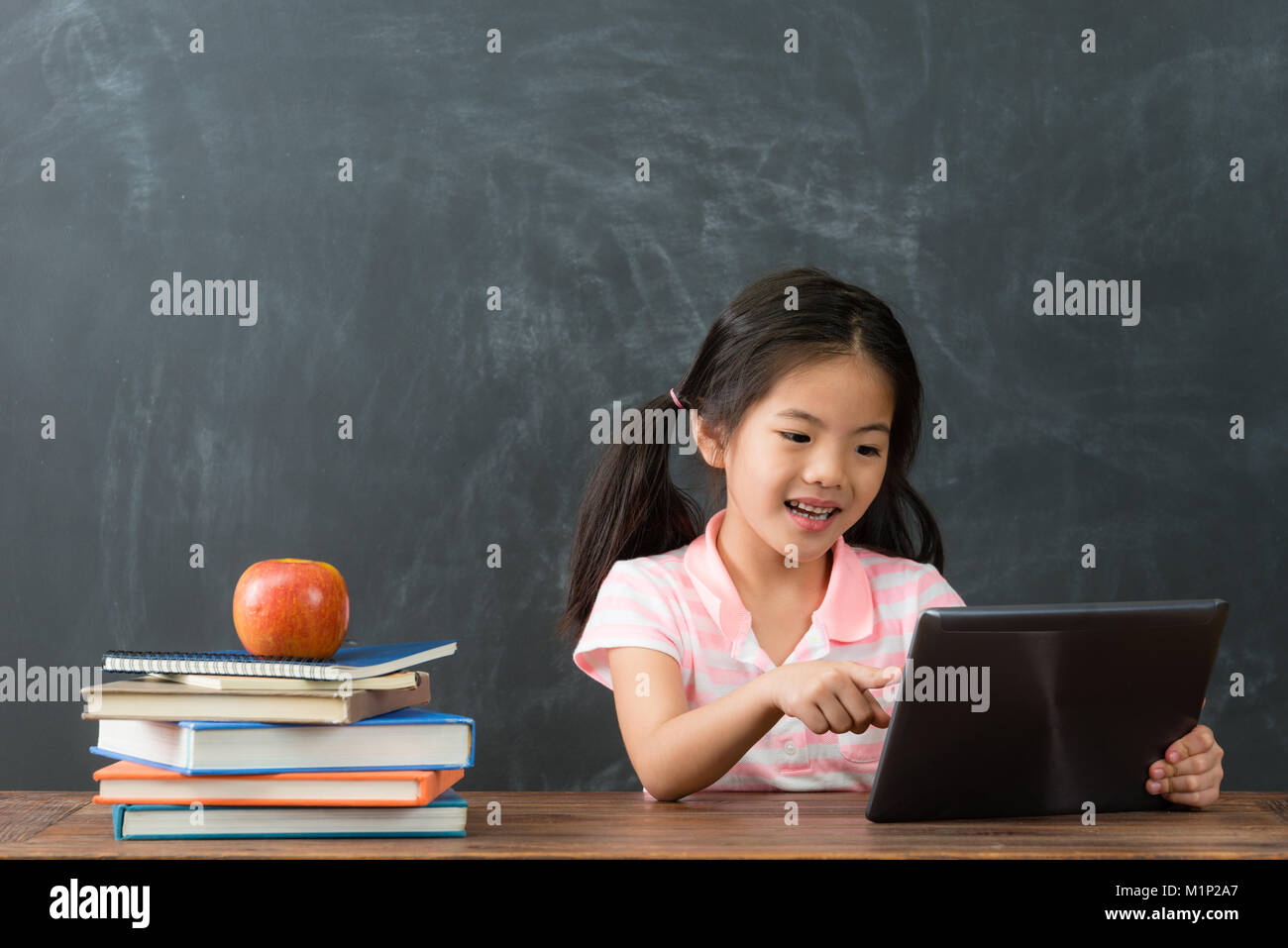 beautiful cute little girl student browsing online e-learning ...