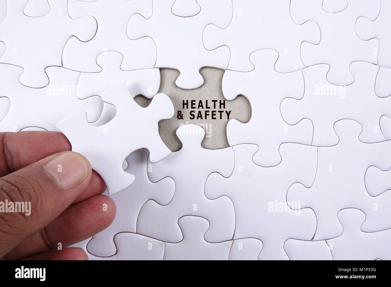 HEALTH AND SAFETY CONCEPT with white jigsaw puzzle Stock Photo - Alamy