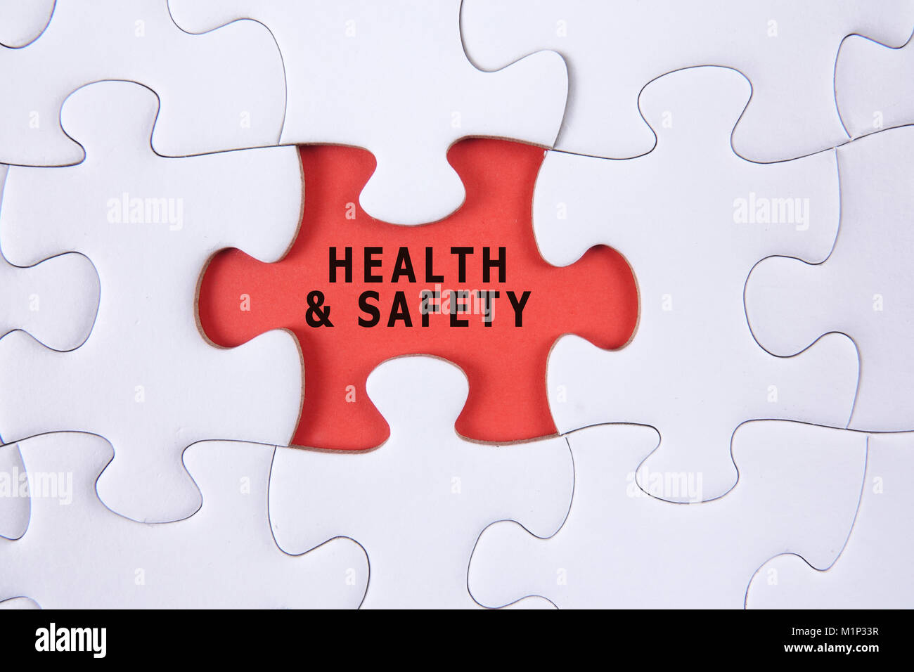 HEALTH AND SAFETY CONCEPT with white jigsaw puzzle Stock Photo - Alamy