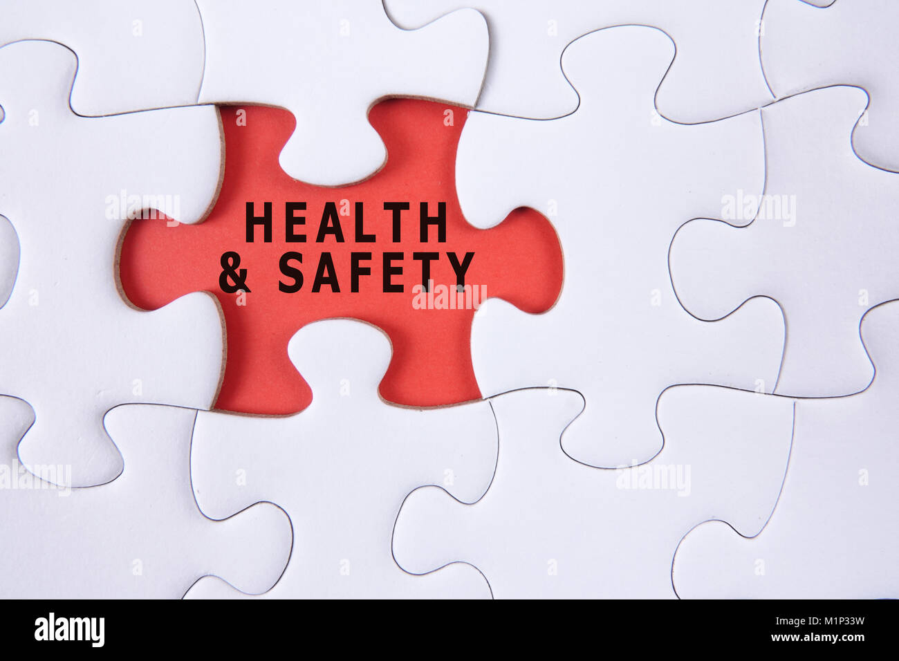 HEALTH AND SAFETY CONCEPT with white jigsaw puzzle Stock Photo - Alamy