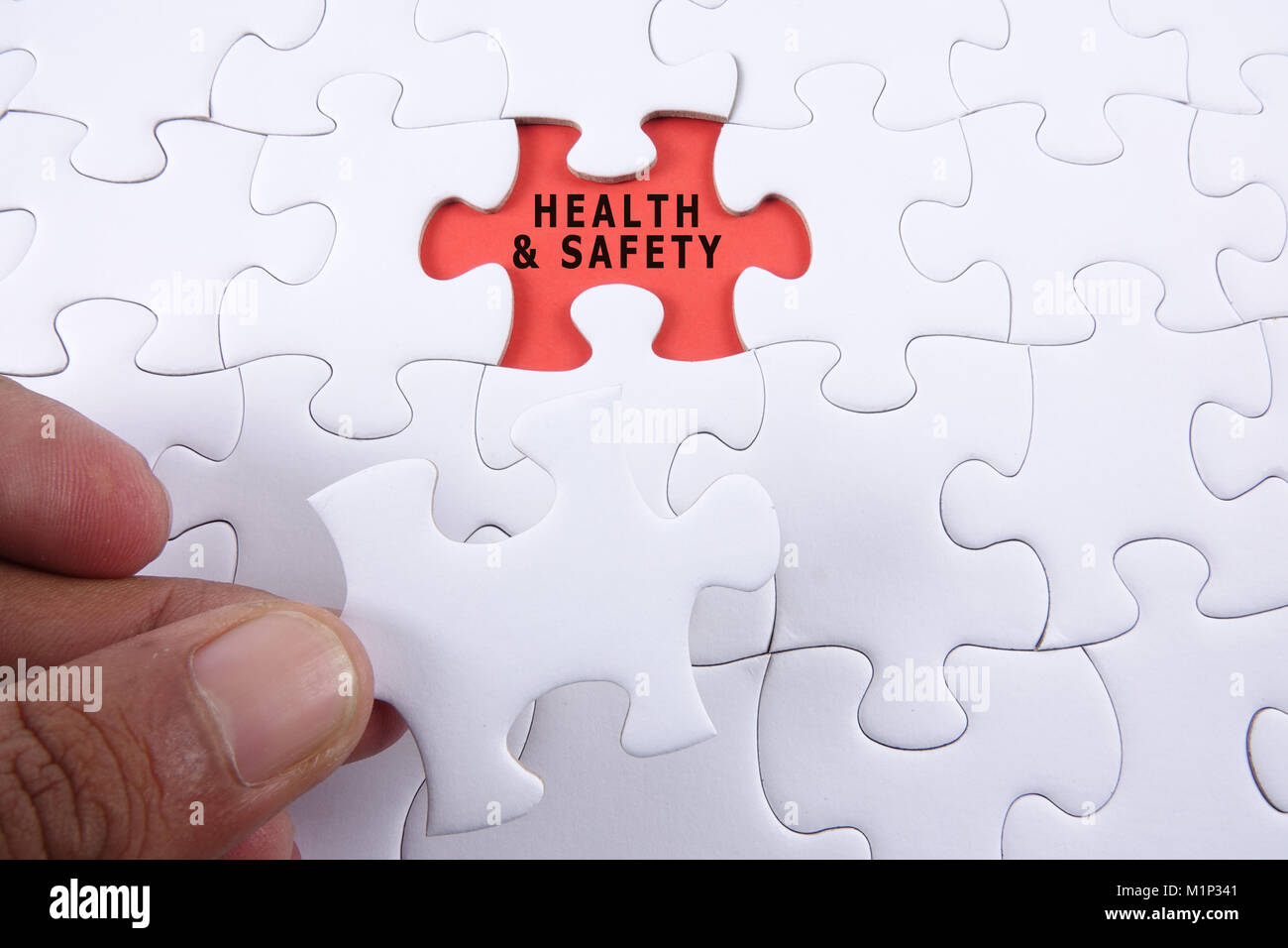 HEALTH AND SAFETY CONCEPT with white jigsaw puzzle Stock Photo - Alamy