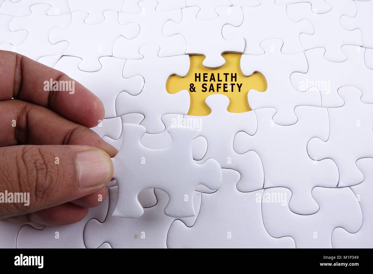 HEALTH AND SAFETY CONCEPT with white jigsaw puzzle Stock Photo - Alamy
