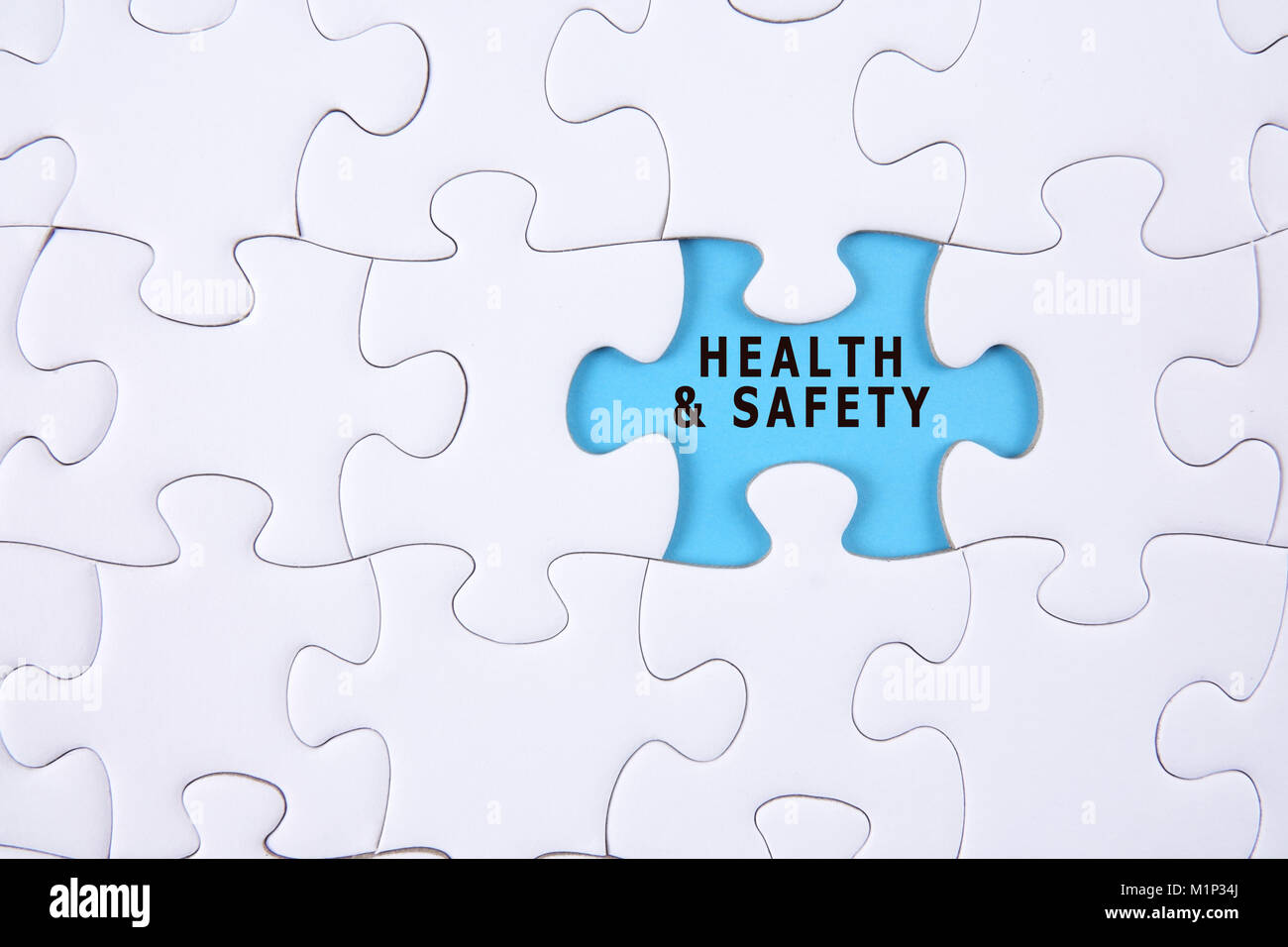 HEALTH AND SAFETY CONCEPT with white jigsaw puzzle Stock Photo - Alamy