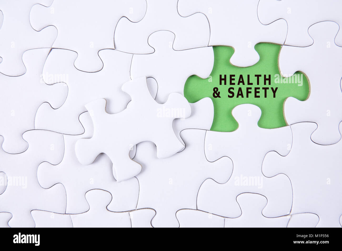 HEALTH AND SAFETY CONCEPT with white jigsaw puzzle Stock Photo - Alamy
