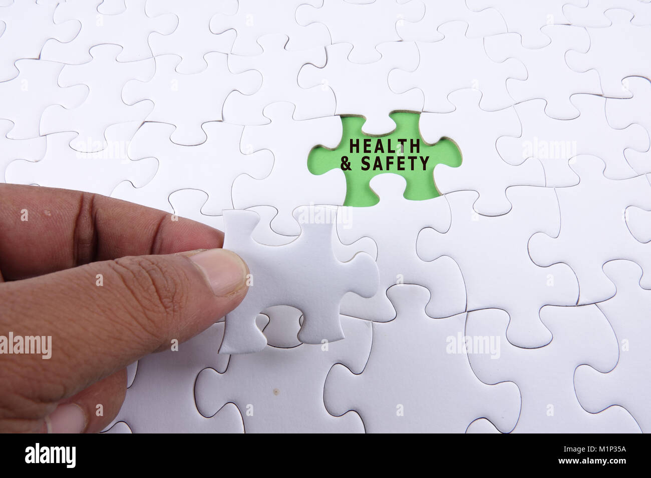 HEALTH AND SAFETY CONCEPT with white jigsaw puzzle Stock Photo - Alamy