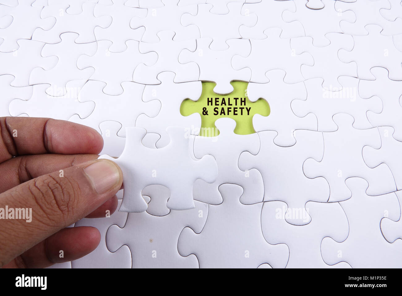 HEALTH AND SAFETY CONCEPT with white jigsaw puzzle Stock Photo - Alamy