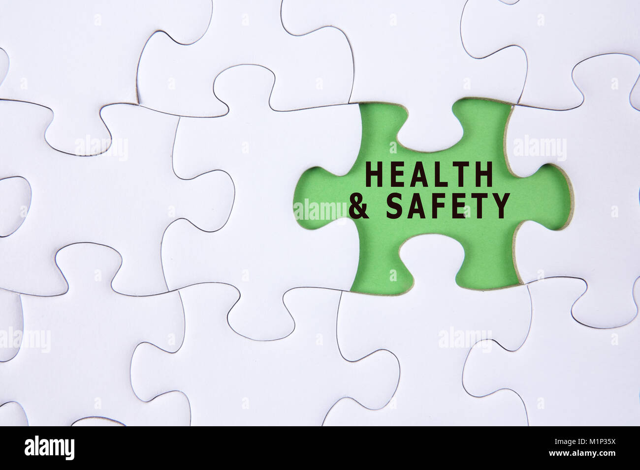 HEALTH AND SAFETY CONCEPT with white jigsaw puzzle Stock Photo - Alamy