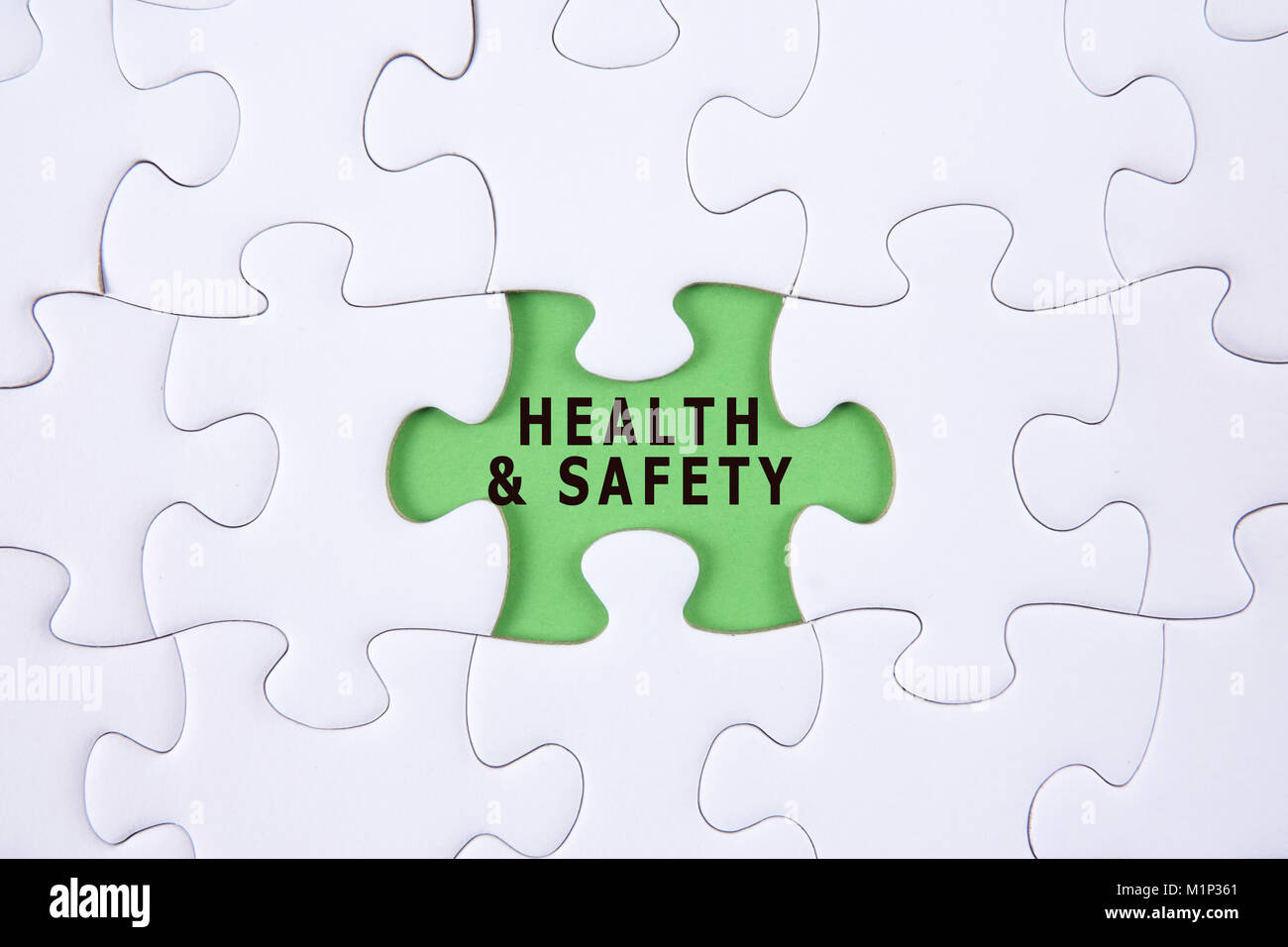 HEALTH AND SAFETY CONCEPT with white jigsaw puzzle Stock Photo - Alamy