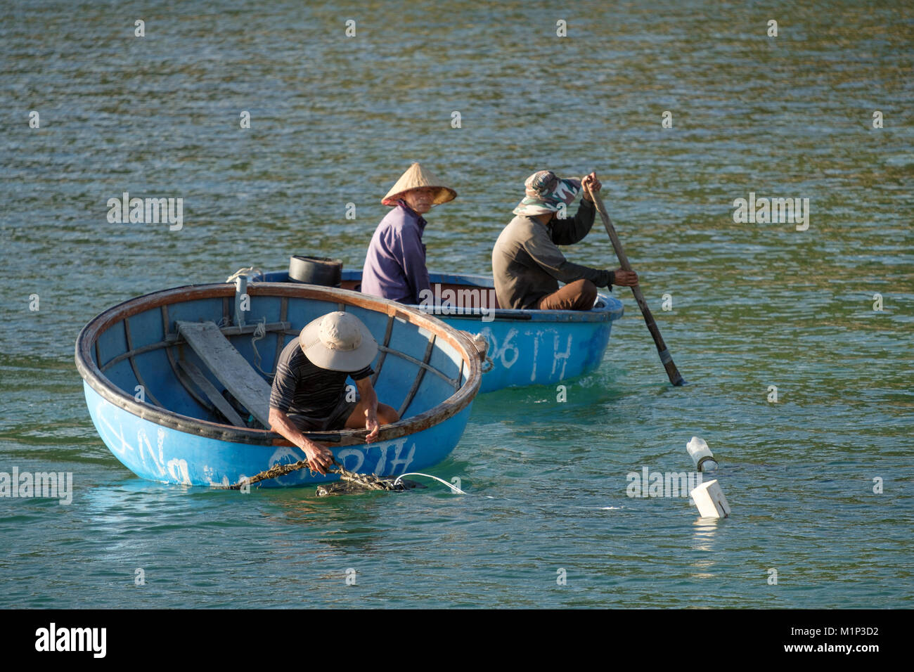 Cham island fishermen in traditional coracle round basket fishing boats ...