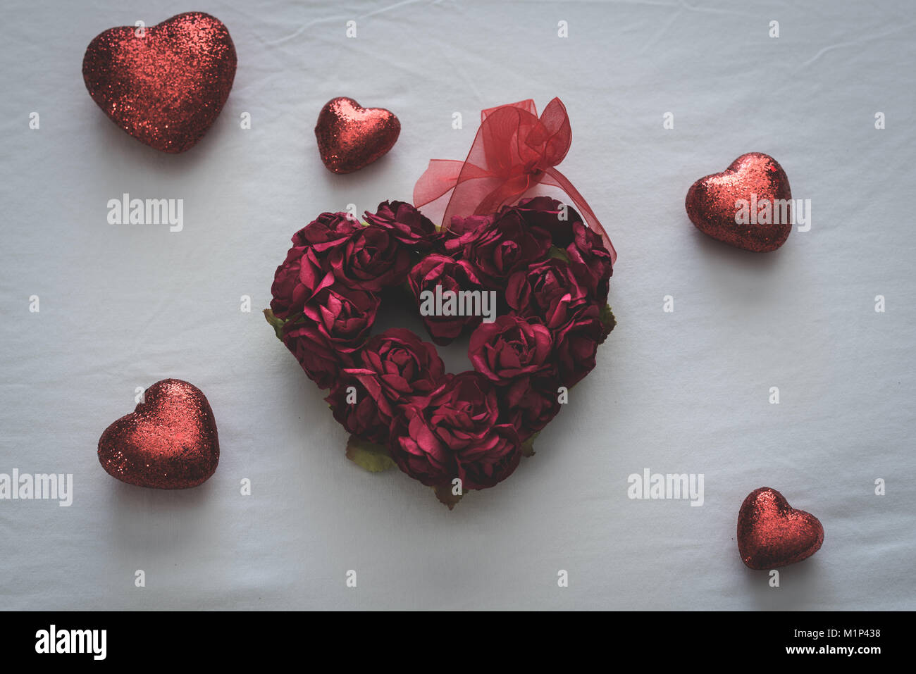 Heart shape made up of small roses surrounded with smaller hearts on ...
