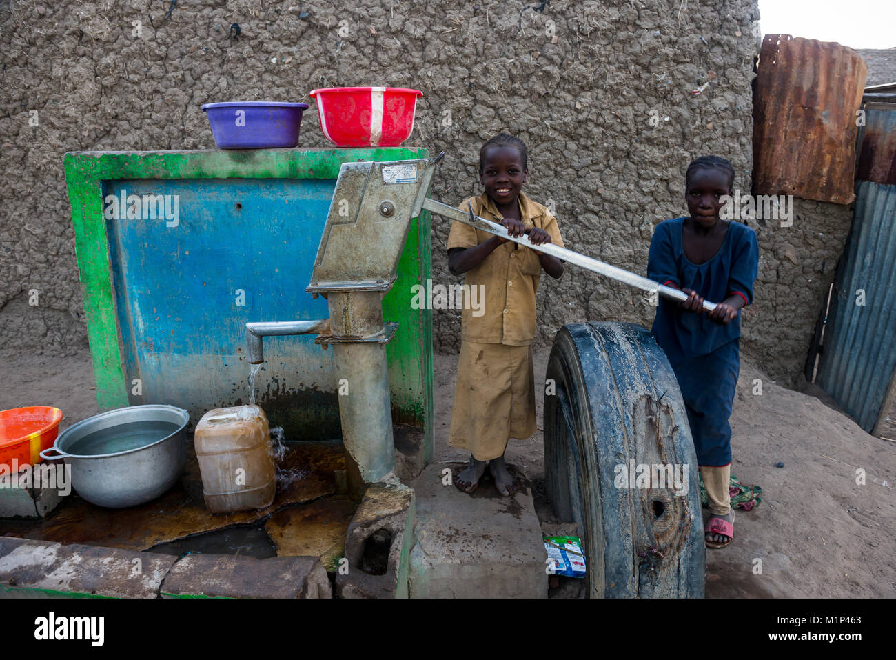 Local kids on a water well, Gaoui, near N'Djamena, Chad, West Africa ...