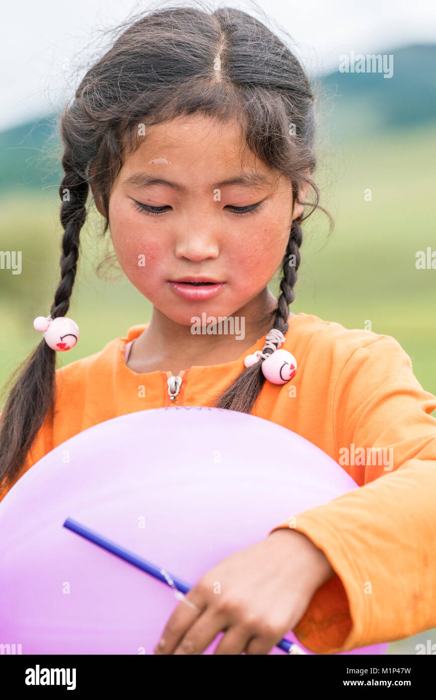 Portrait of a Mongolian Nomadic girl with braids, North Hangay province ...