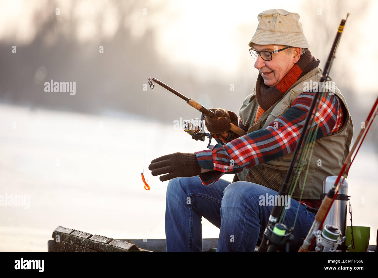 Old fisherman fishing on river Stock Photo - Alamy