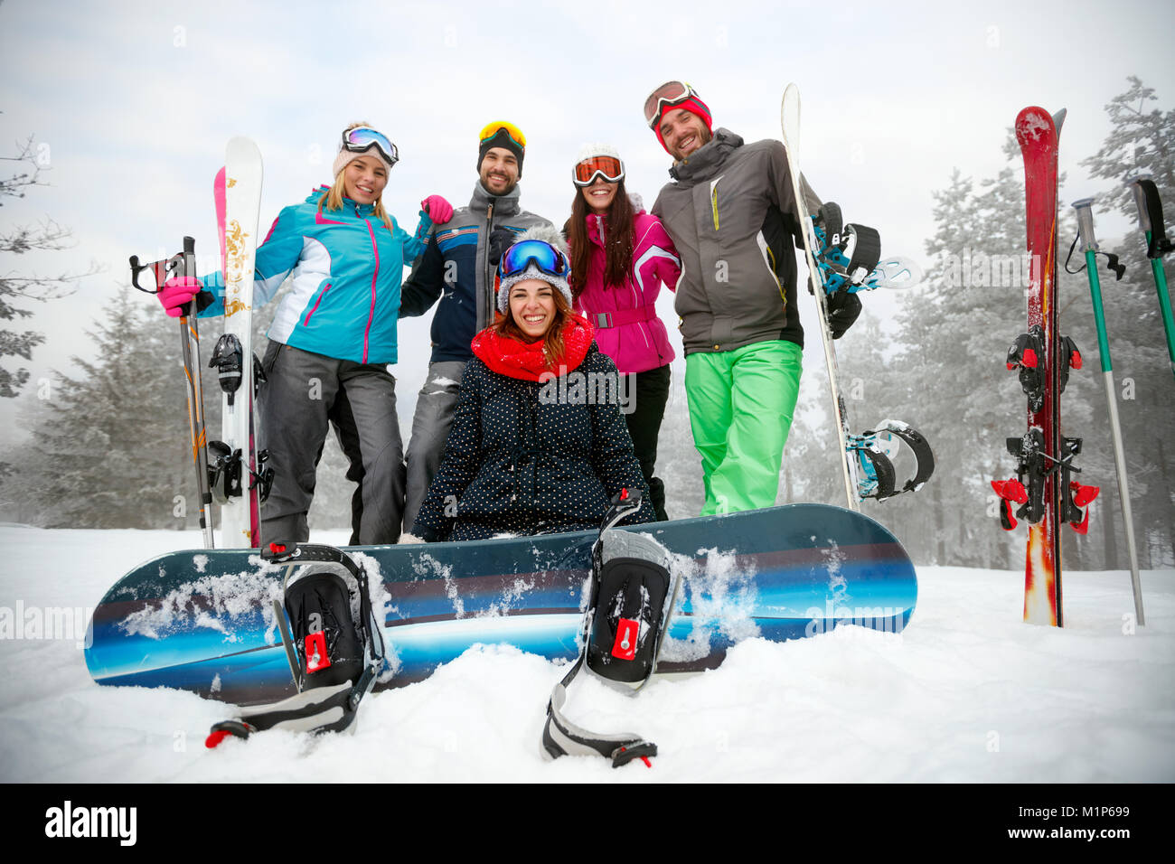 Group of friends snowboarders and skiers have fun on the slope Stock ...
