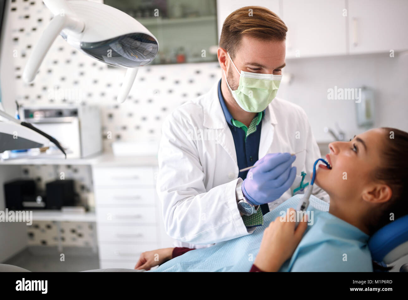 Dentist checkup female patient in dental chair Stock Photo - Alamy