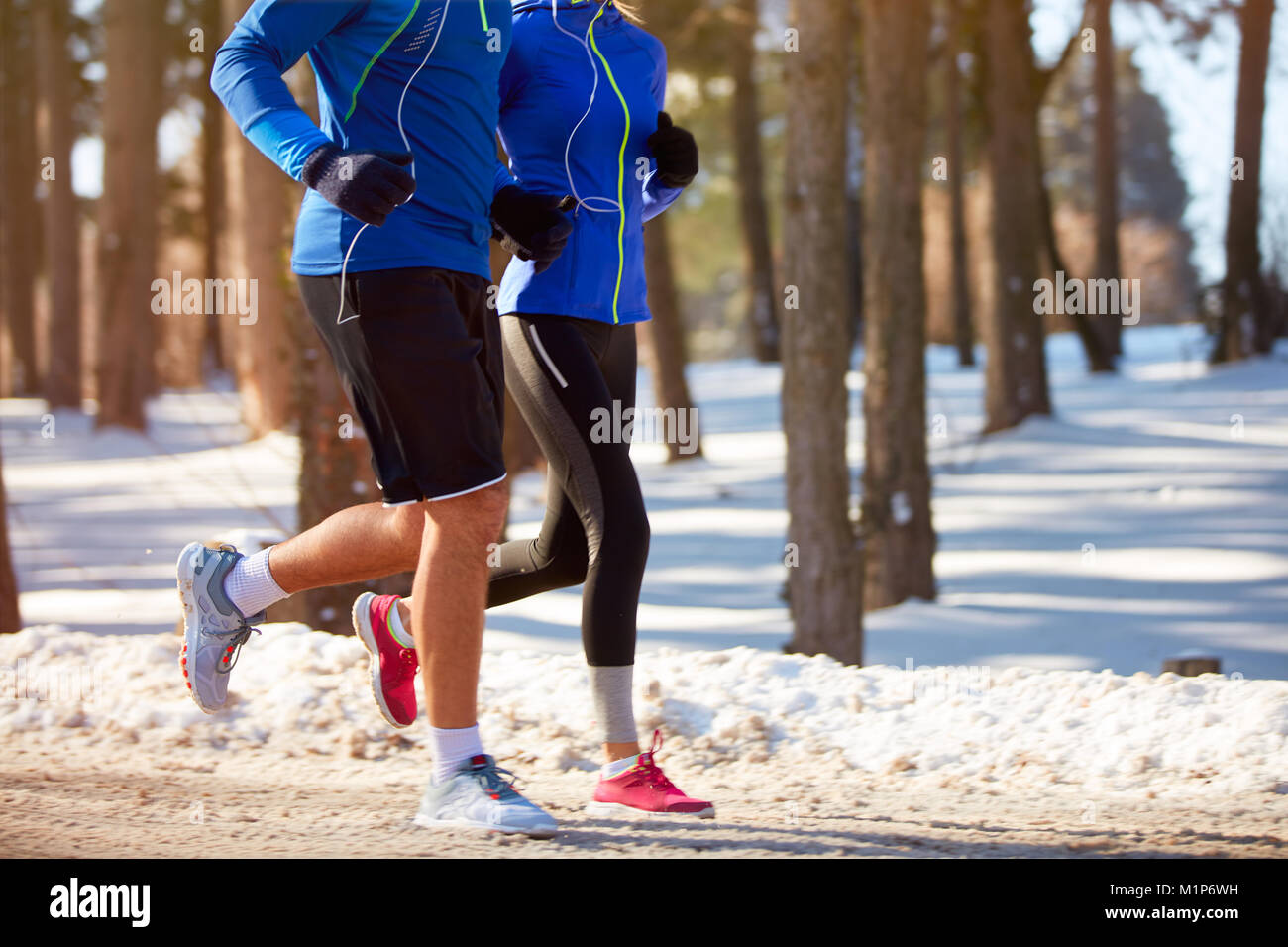 Couple of runners jogging together, athlete body Stock Photo - Alamy