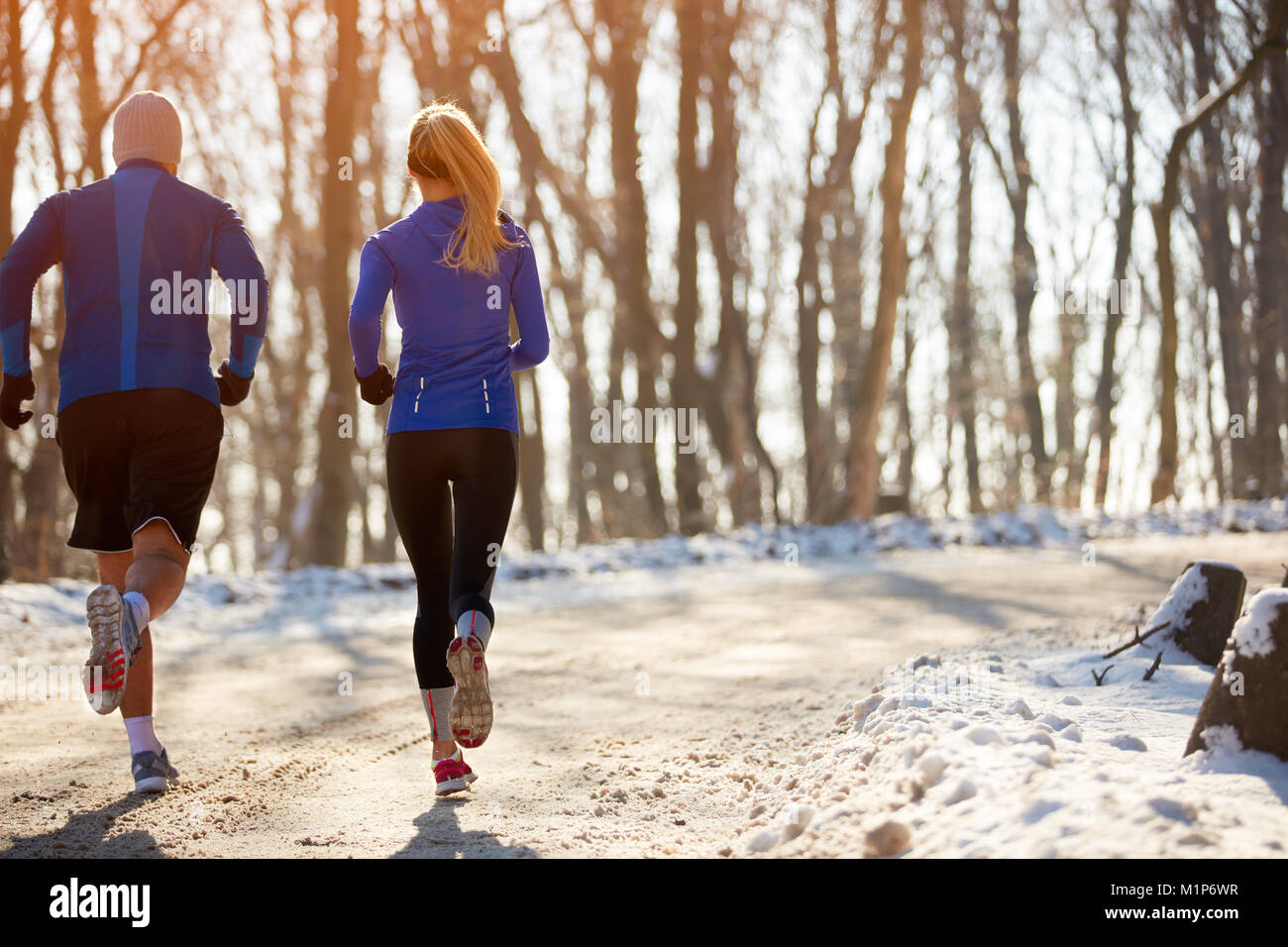 Couple jogging in nature together, back view Stock Photo - Alamy