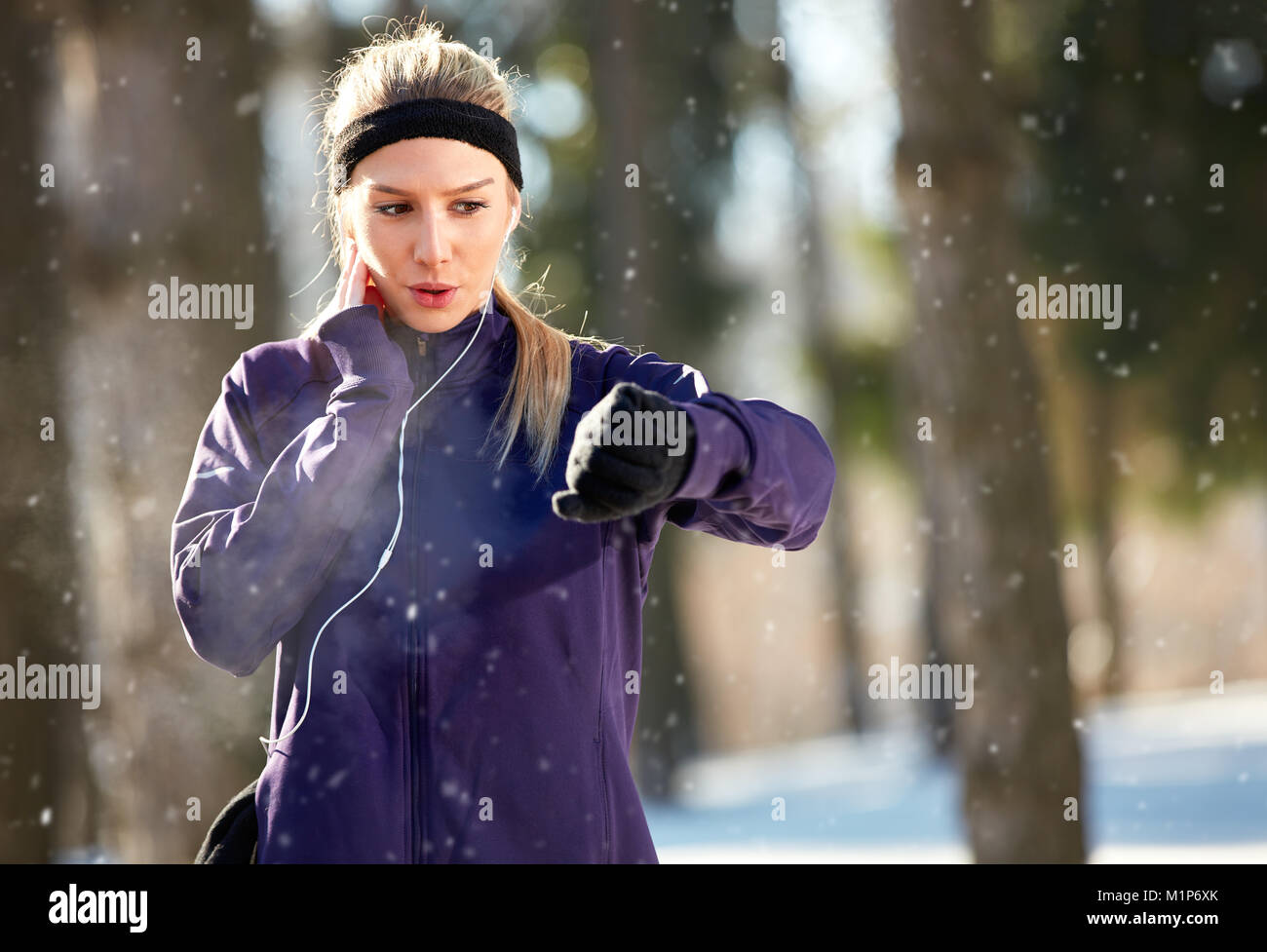 Female measures pulse on training outdoor Stock Photo - Alamy