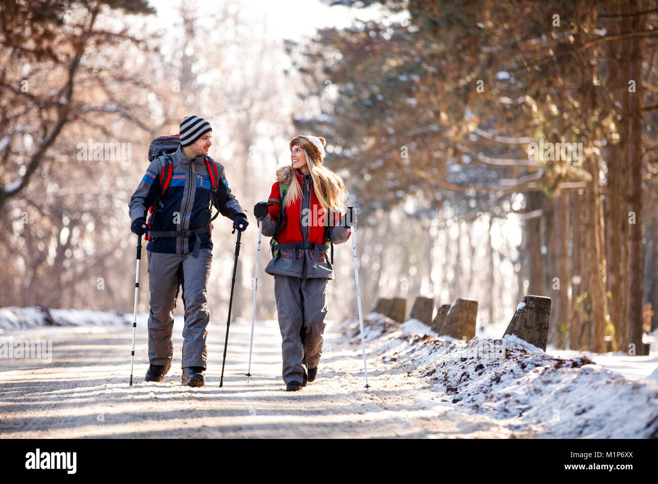 Couple of hikers walking and talking in nature in winter Stock Photo ...