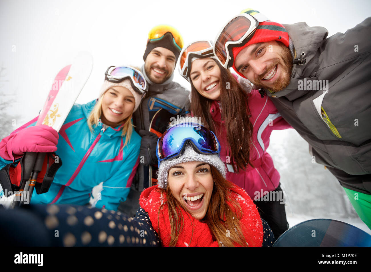 Happy group of young skiers on skiing together Stock Photo - Alamy