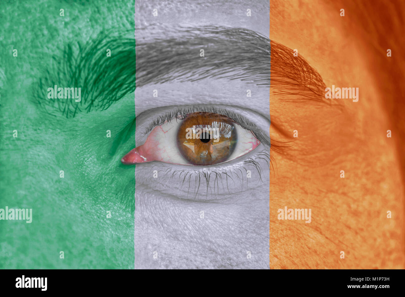 Human face and eye painted with flag of Ireland Stock Photo - Alamy