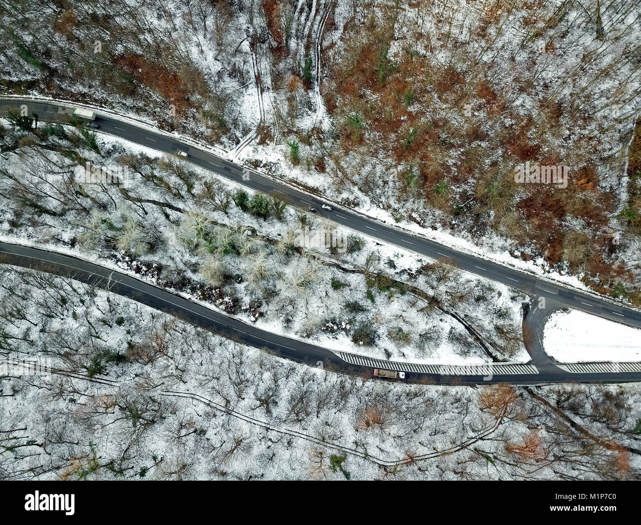 View from height on car driving through winter forest road. aerial eye ...