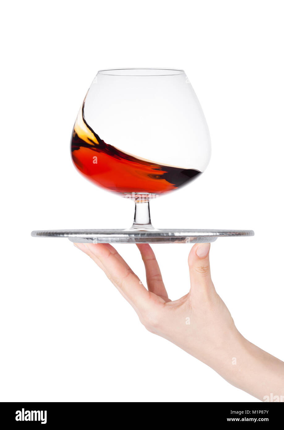 Hand holds tray with glass of brandy cognac on white background Stock ...