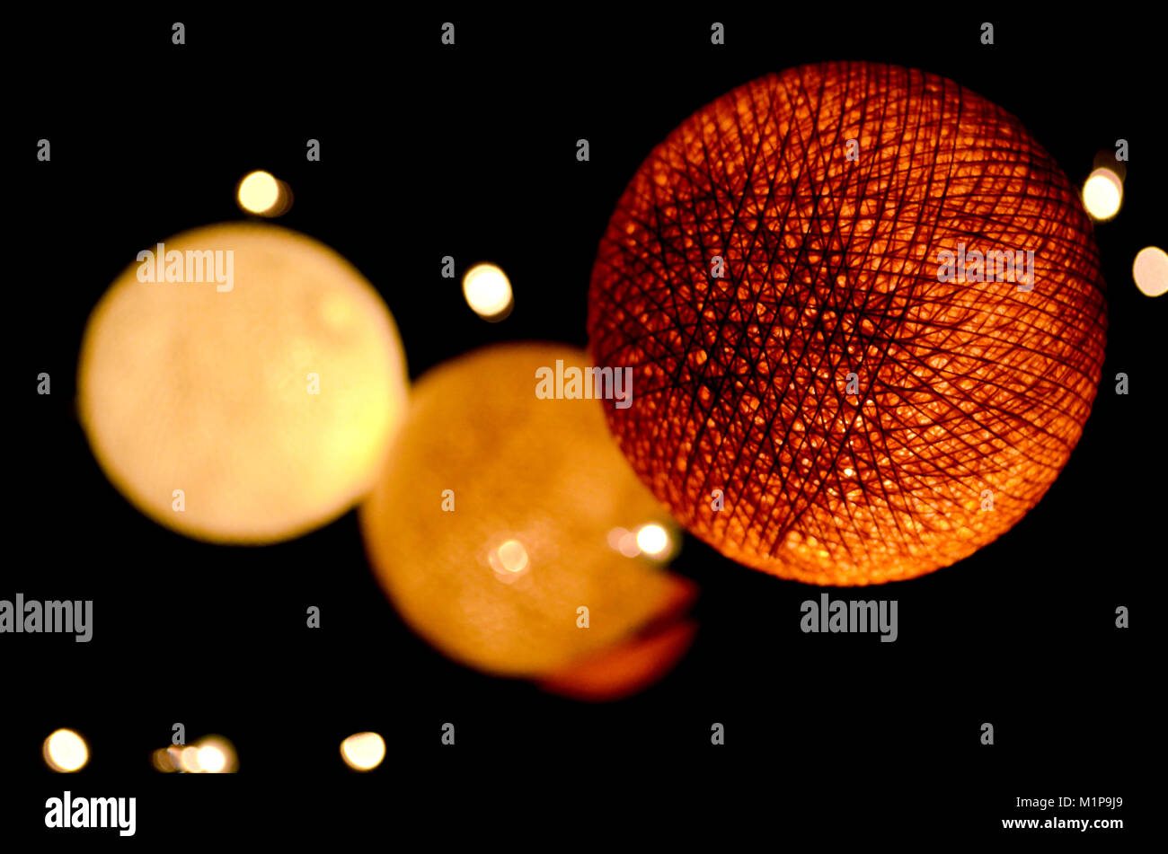 Macro shot of colorful Christmas decorations. Light bulbs made of yarn ...
