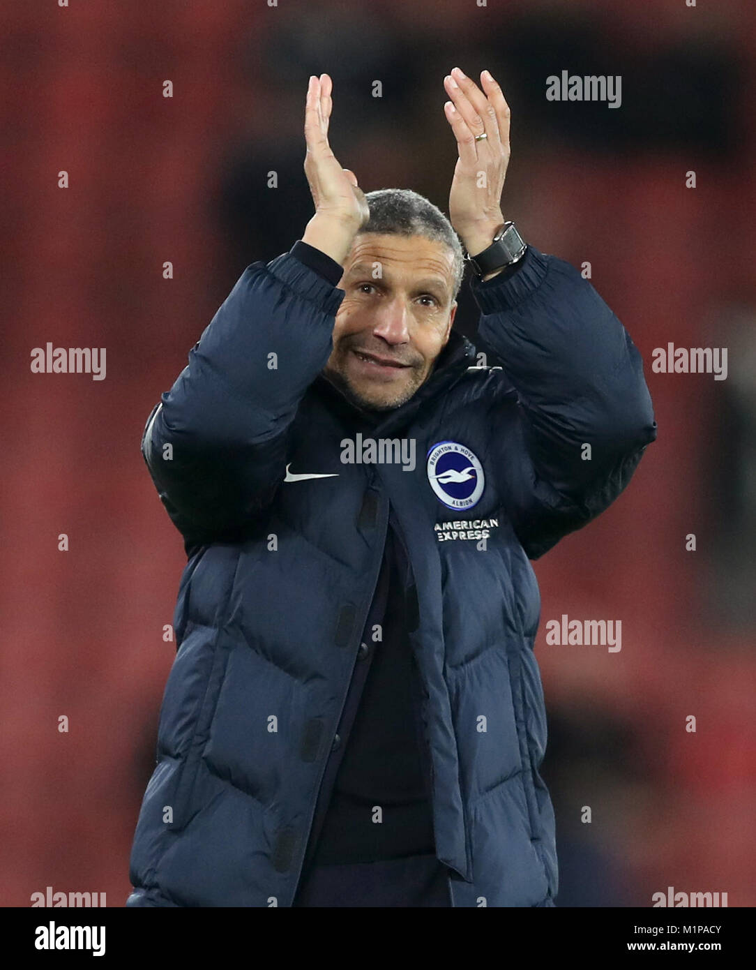 Brighton & Hove Albion manager Chris Hughton applauds the fans after ...