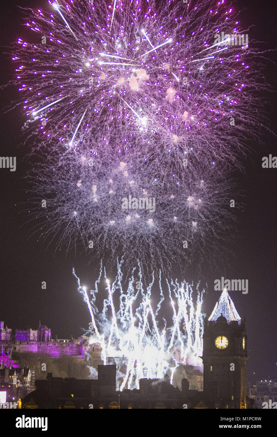 Midnight fireworks from Edinburgh Castle with the Balmoral Clock in the ...