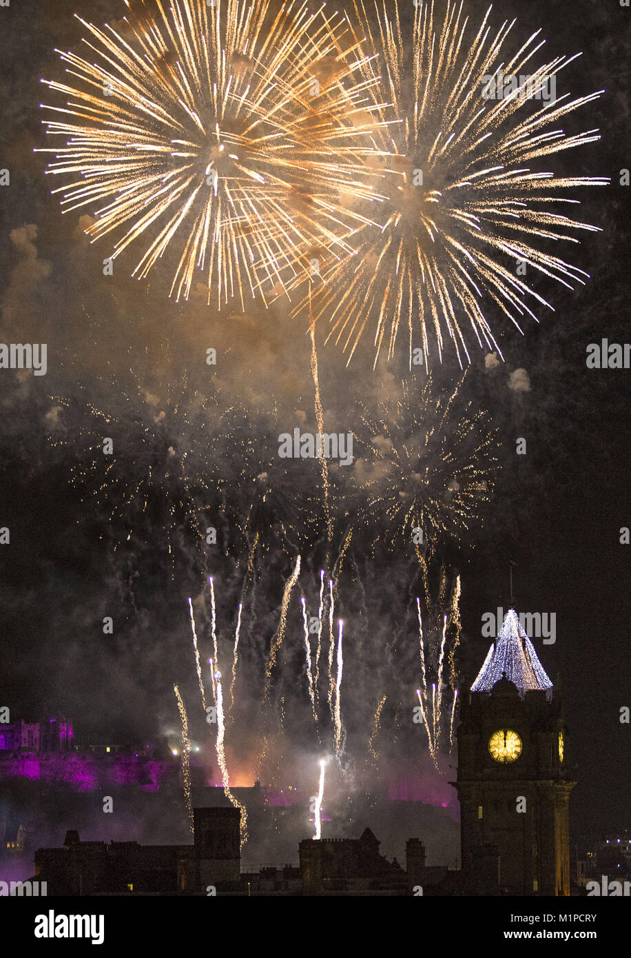 Midnight fireworks from Edinburgh Castle with the Balmoral Clock in the ...