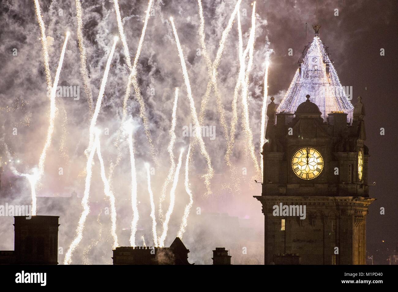 Midnight fireworks from Edinburgh Castle with the Balmoral Clock in the ...