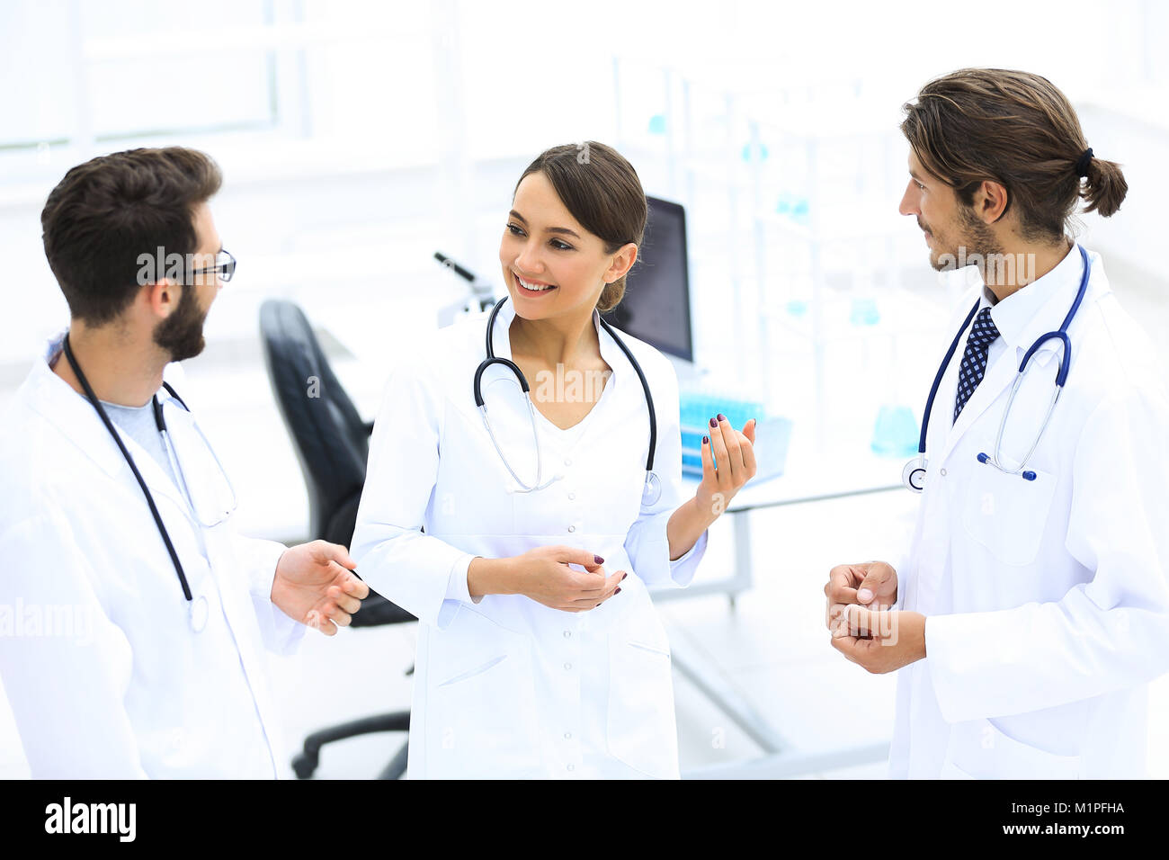 Team of different doctors having conversation Stock Photo - Alamy
