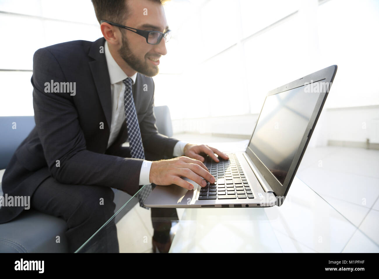 Concentrated professional IT developer with laptop Stock Photo - Alamy