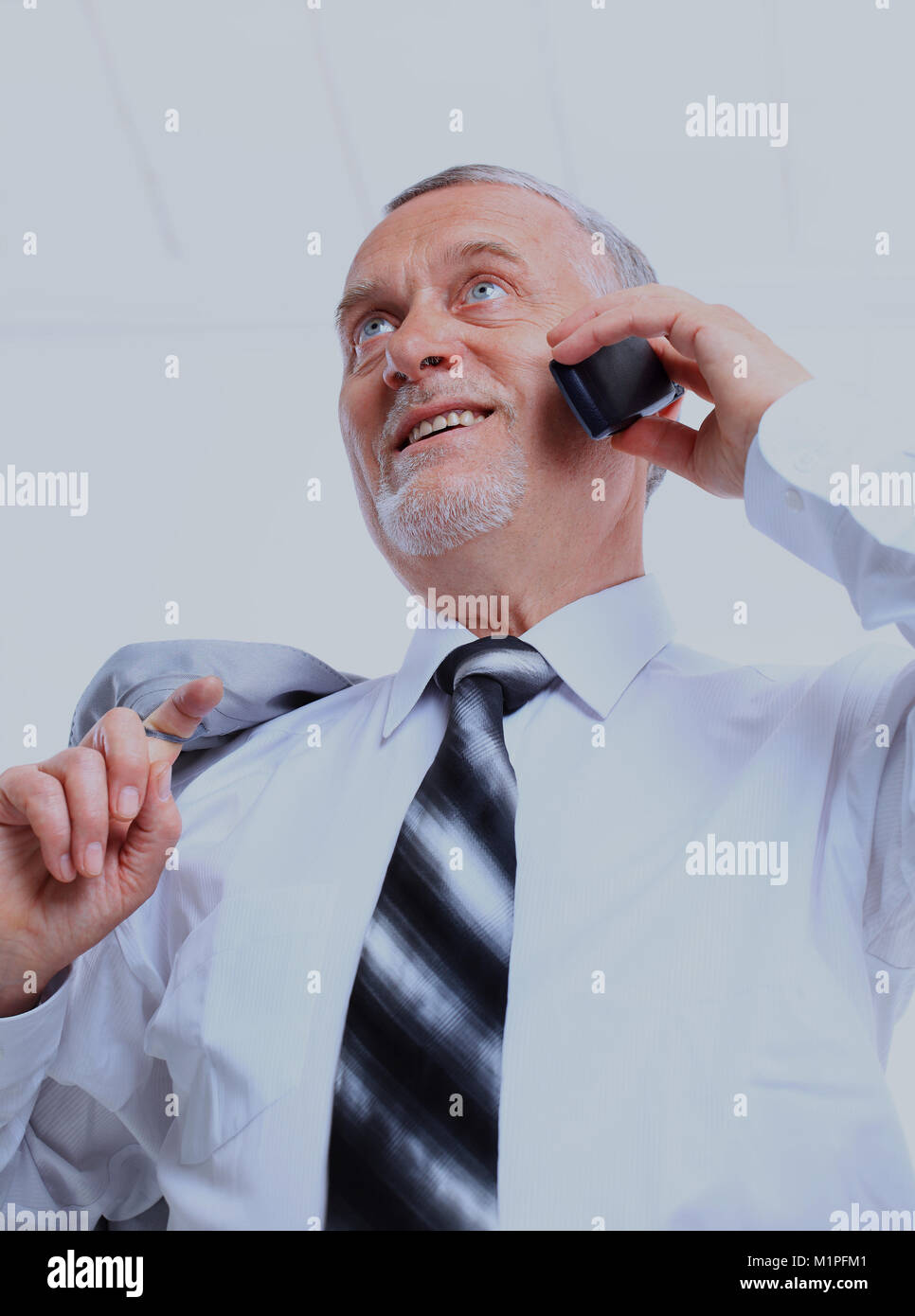 Portrait of a business man with phone isolated on white background ...