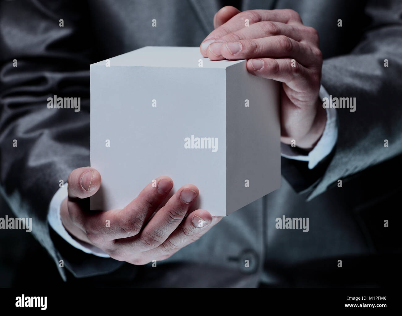 Cube in the male hands Stock Photo - Alamy