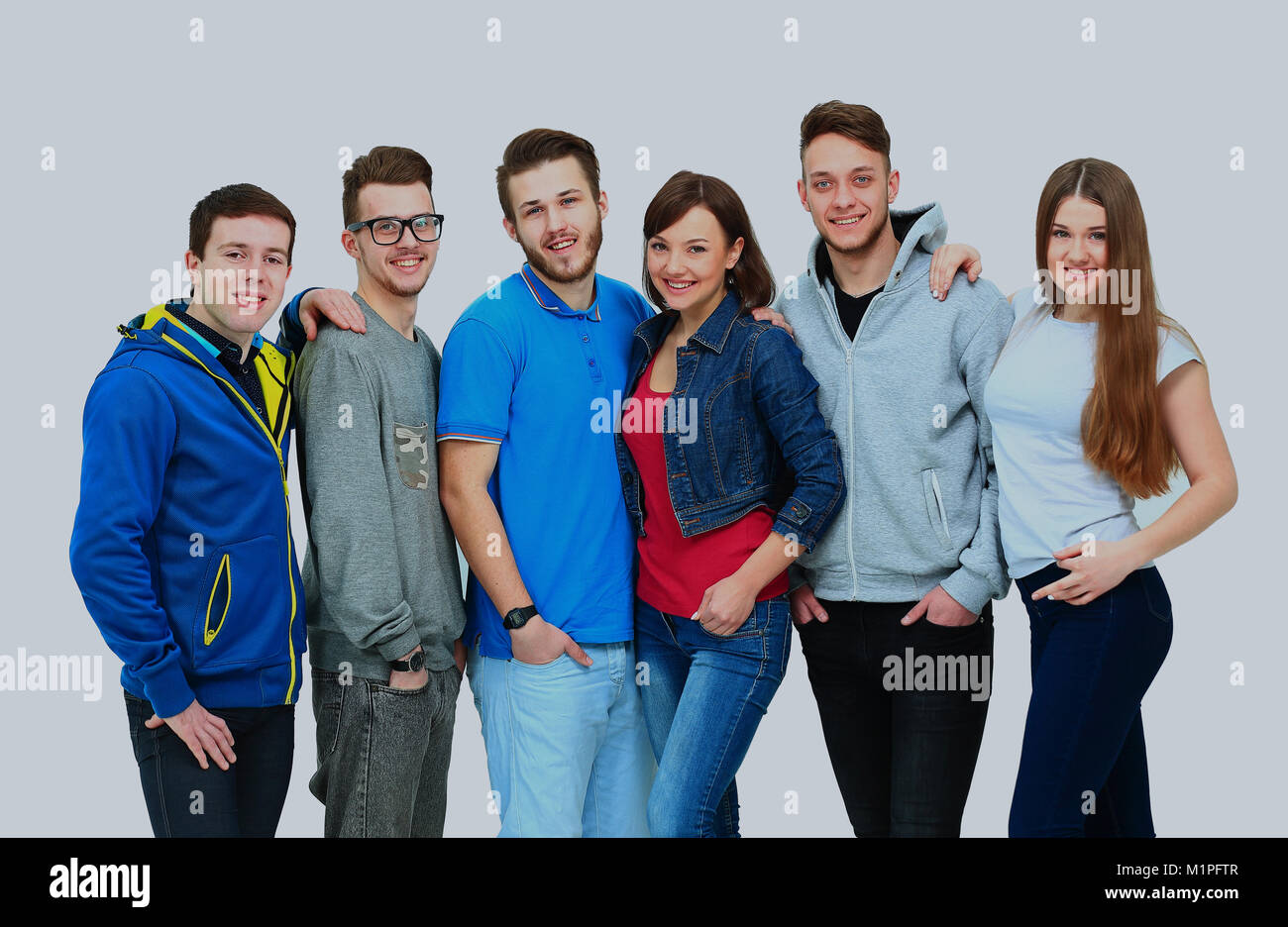 group of smiling friends staying together and looking at camera ...