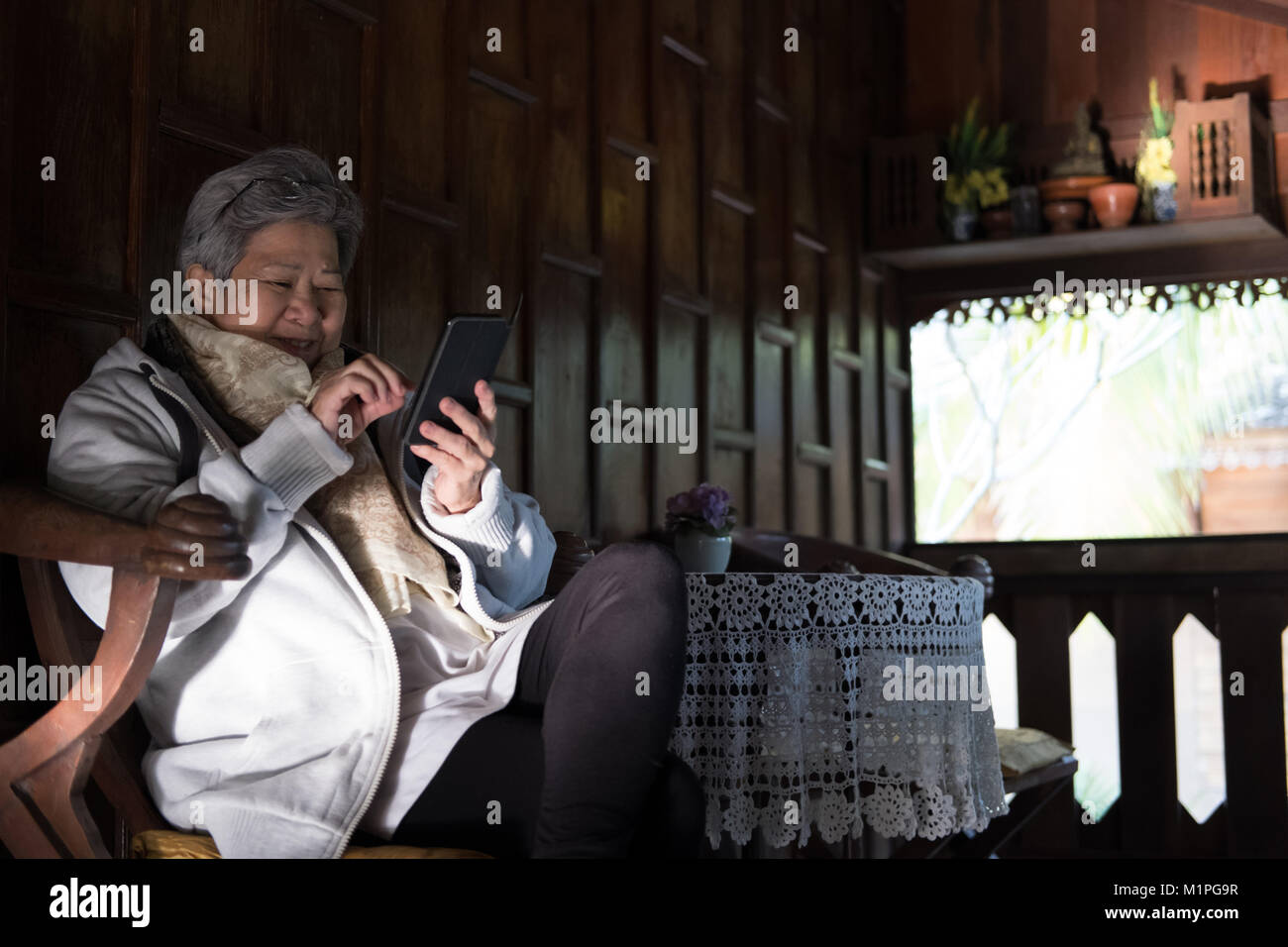 Elderly woman smartphone on balcony hi-res stock photography and images ...