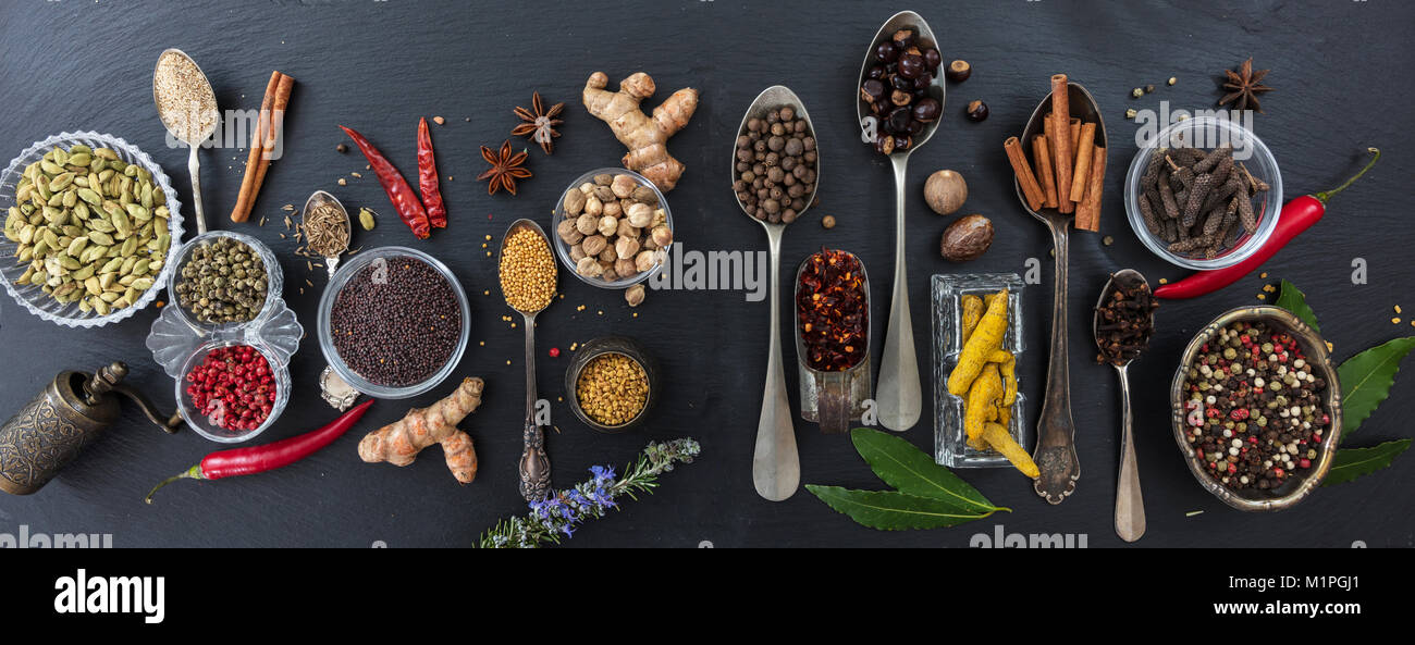Spices and herbs on black stone background, top view, banner Stock ...