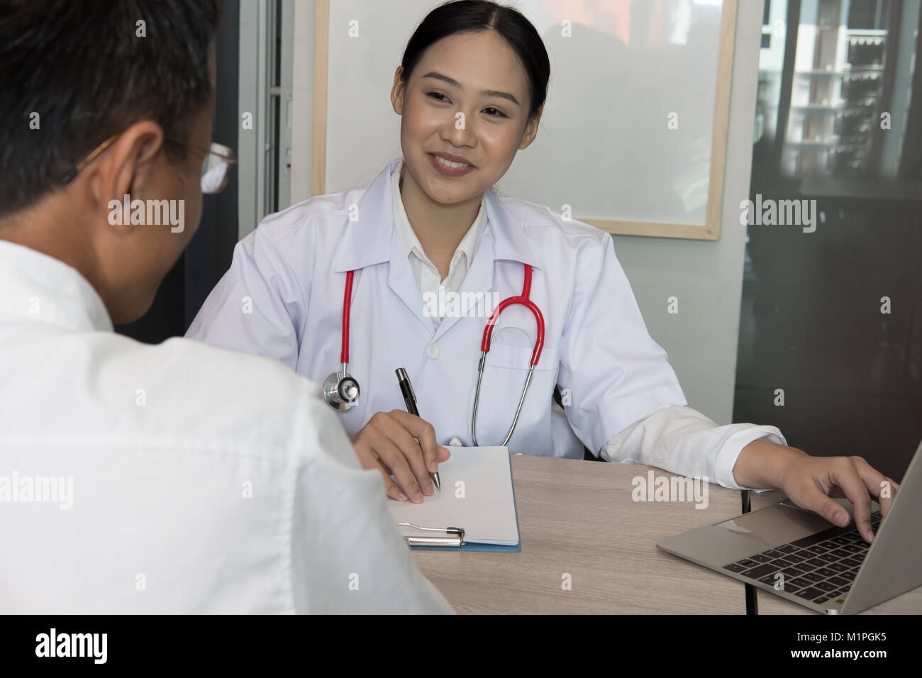 doctor explaining to male patient about diagnosis at hospital. medical ...