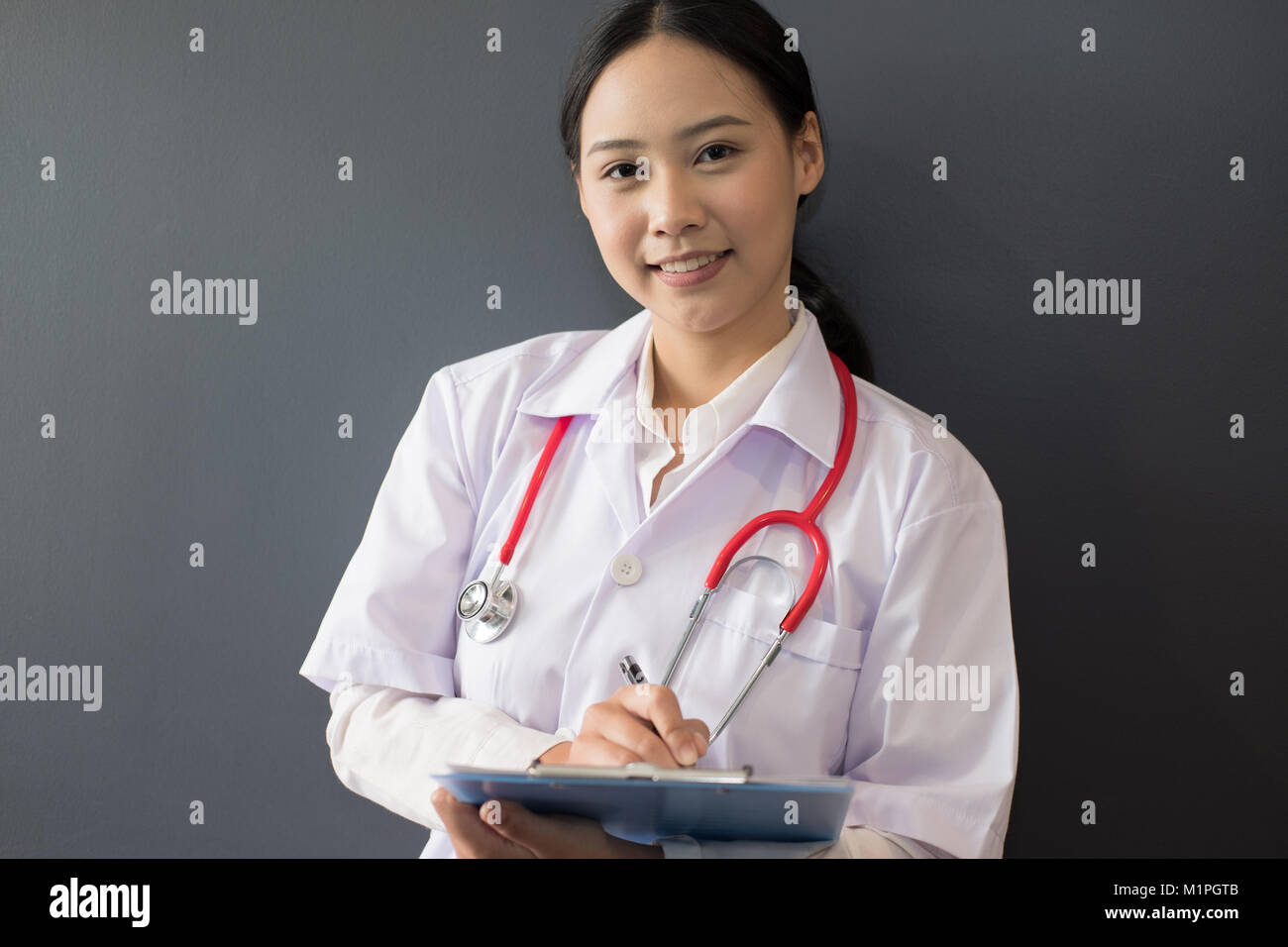 doctor write on medical examination or prescription note at hospital ...